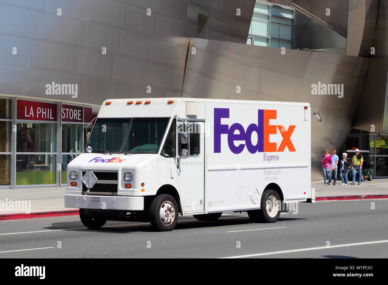 LOS ANGELES, USA - APRIL 5, 2014: People walk by FedEx van parked in ...