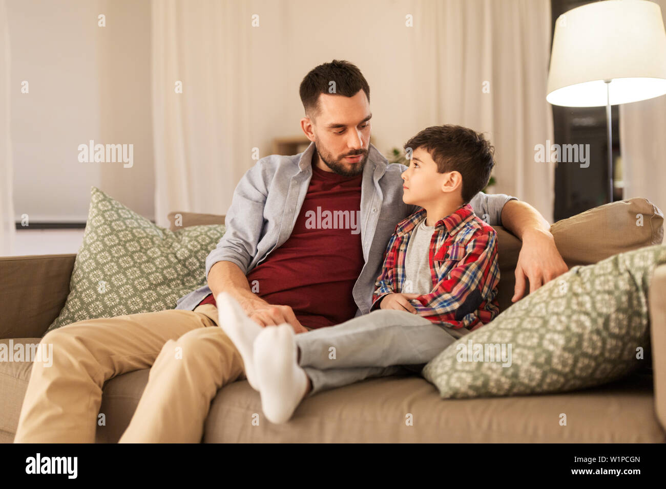 father talking to his sad little son at home Stock Photo - Alamy