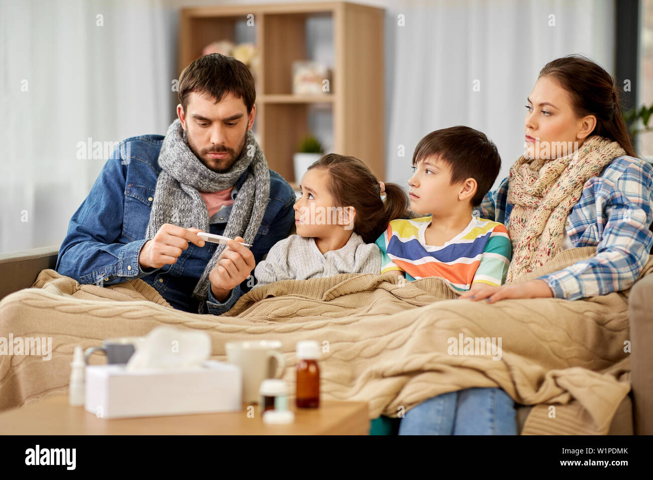 family with ill children having fever at home Stock Photo - Alamy