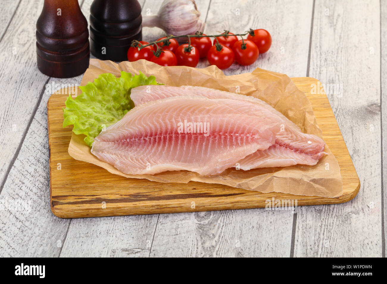 Raw tilapia fish ready for cooking Stock Photo - Alamy