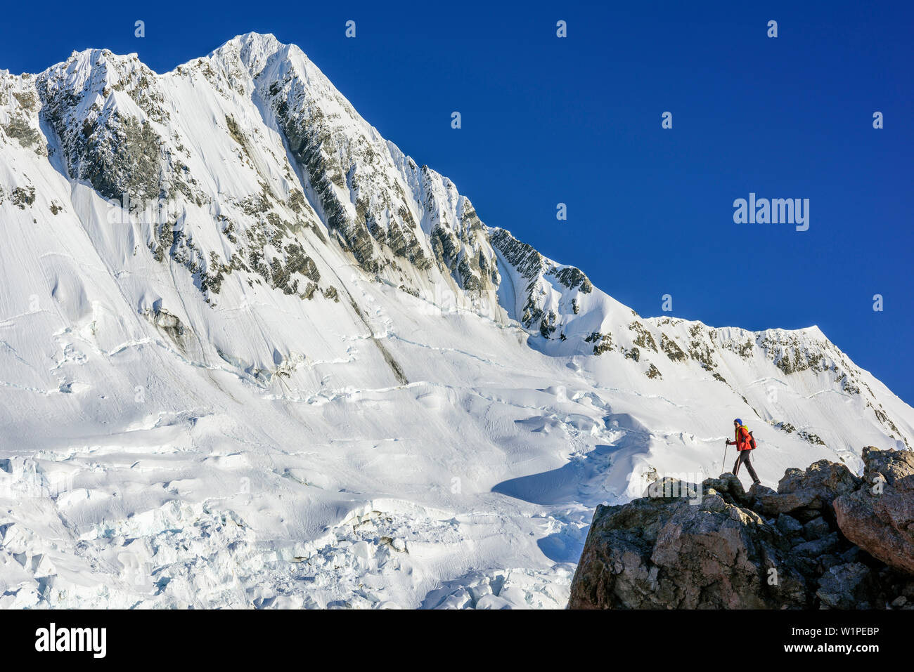 Woman sitting on rock, Footstool in background, from Mueller Hut ...