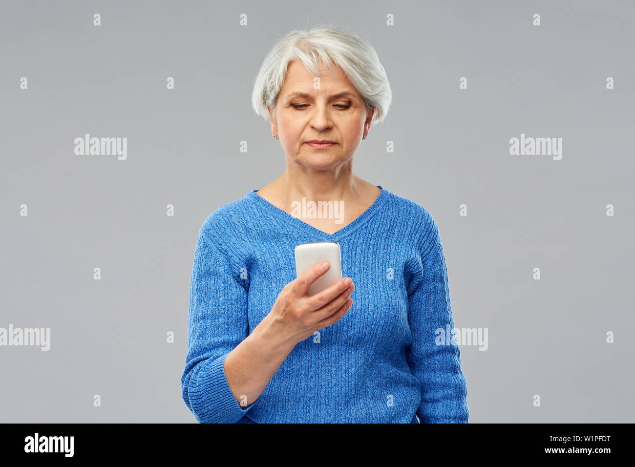 Serious older woman using hi-res stock photography and images - Alamy