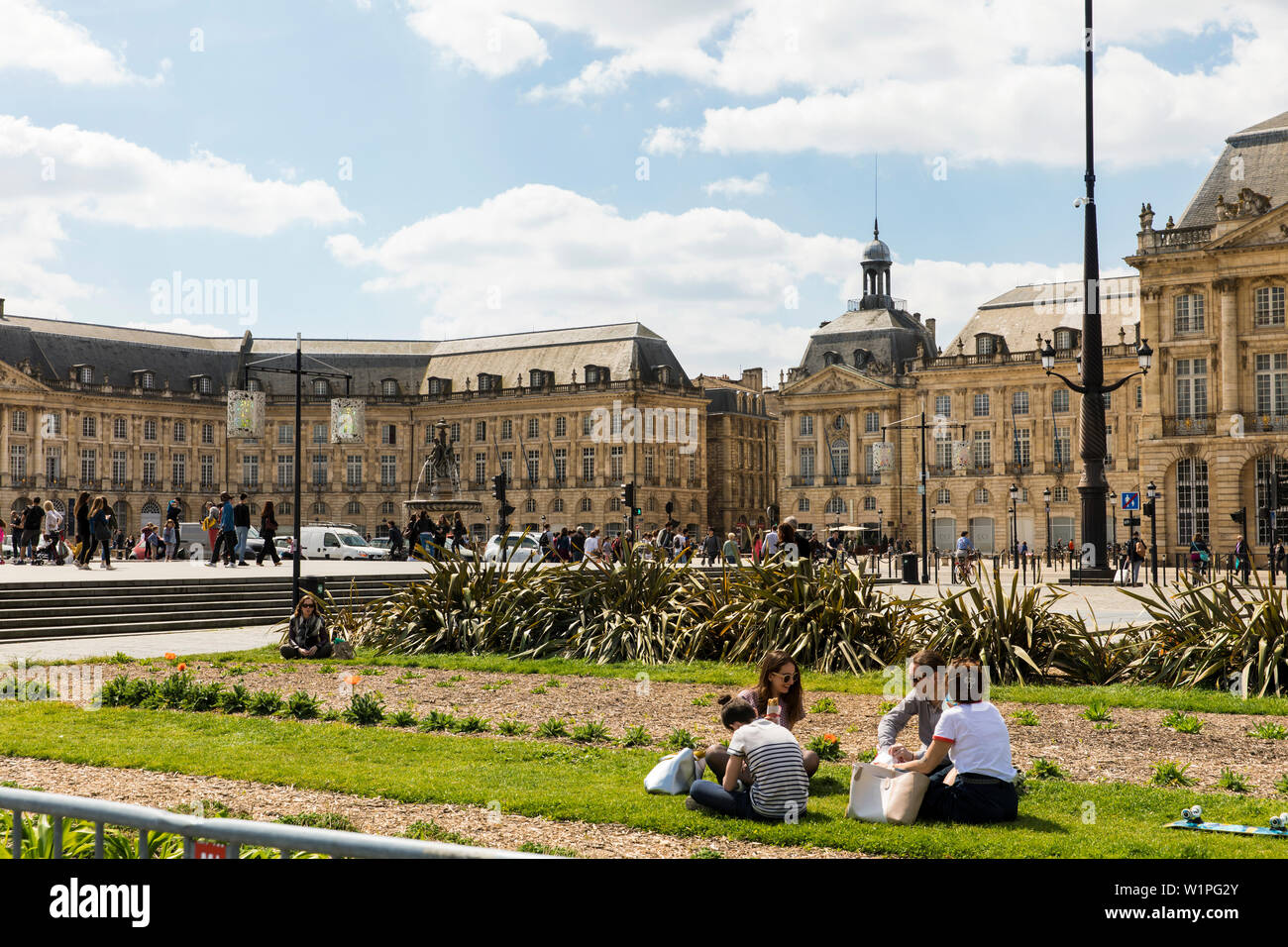 Place de la Bourse with young people sitting on the gras Stock Photo ...