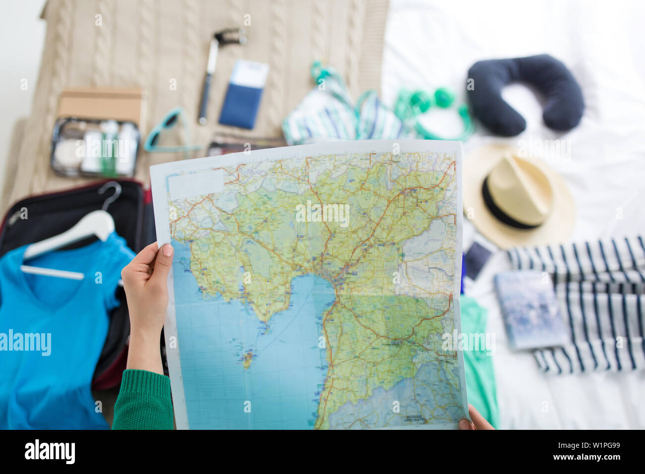 woman with map at home preparing for travel Stock Photo - Alamy