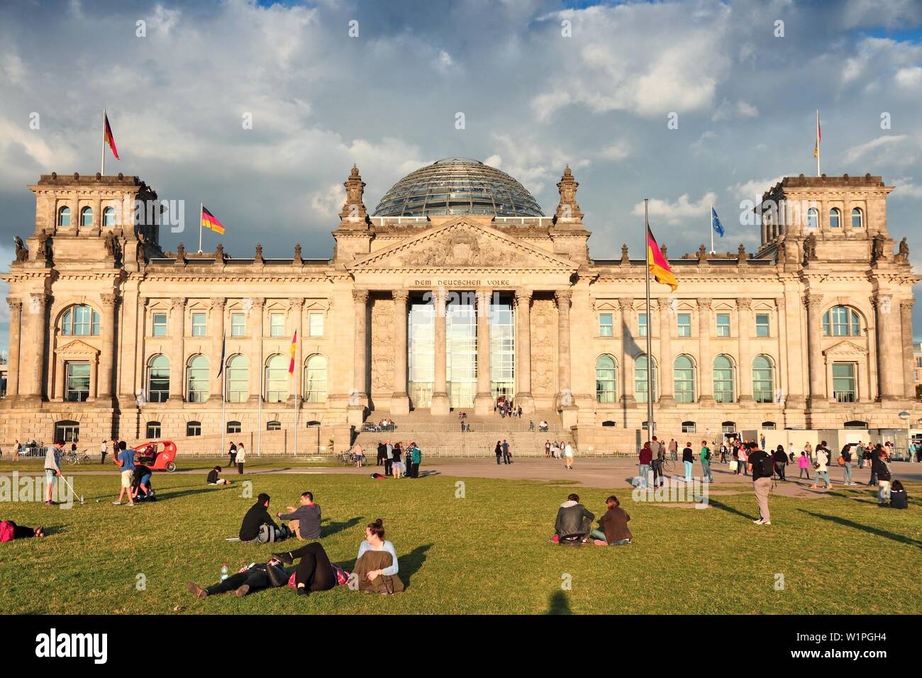 BERLIN, GERMANY - AUGUST 27, 2014: People rest on lawn in front of ...