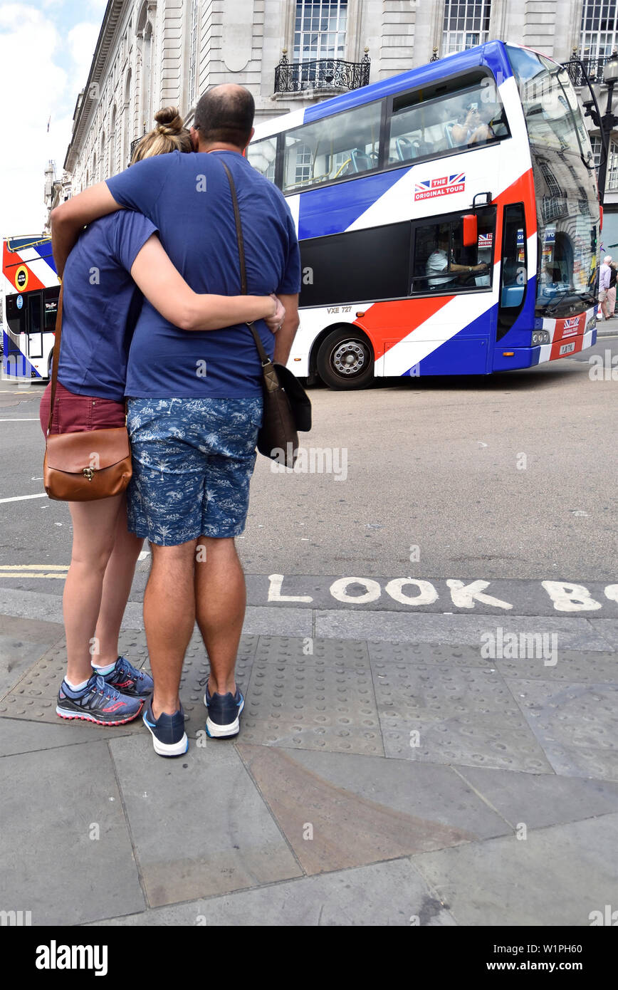 London, England, UK. Couple embracing in Piccadilly Circus - Union Jack ...