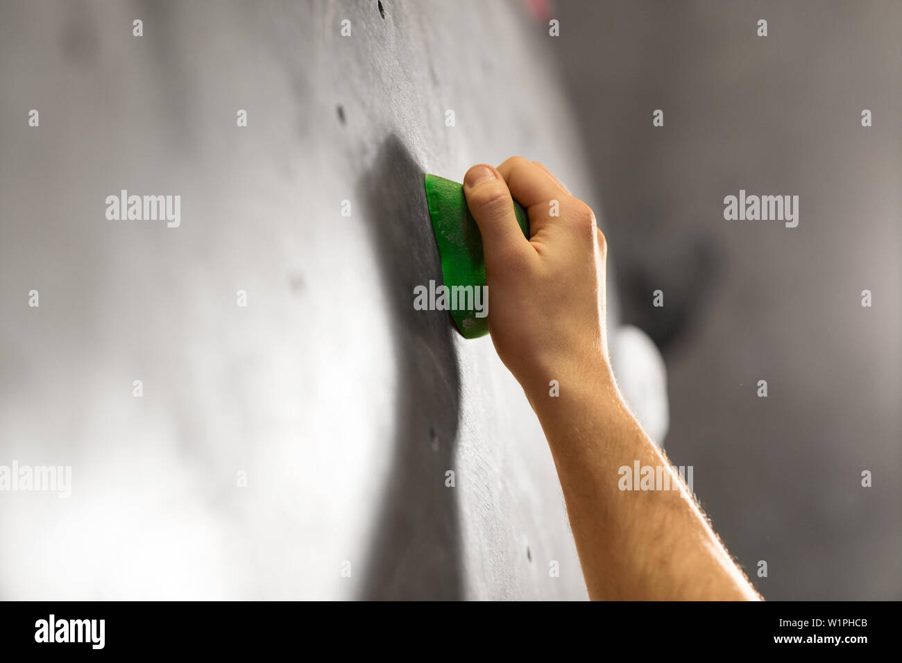 male hand holding to indoor climbing wall Stock Photo - Alamy