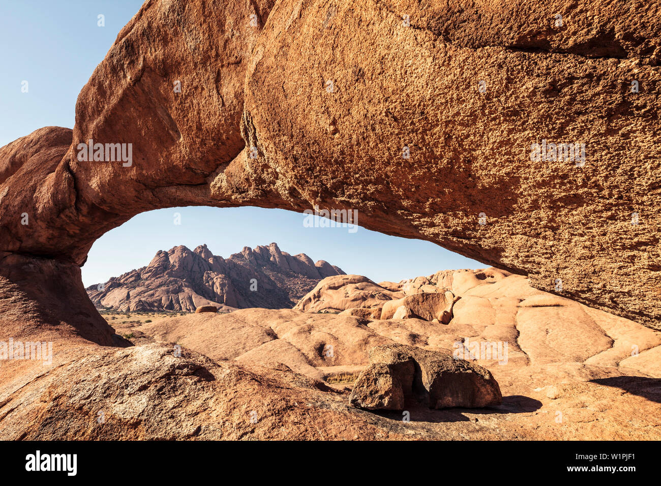 Pontok mountains, seen thorugh a rock arch, Spitzkoppe, Erongo, Namibia ...