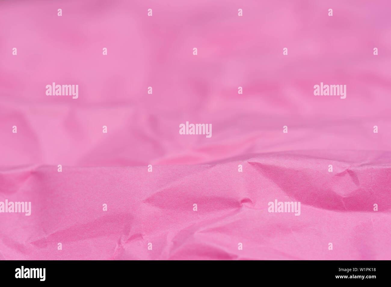 pink creased color paper texture background selective focus closeup ...