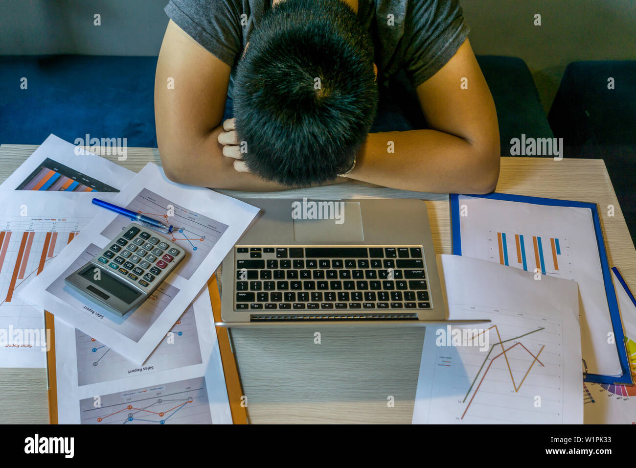 Exhausted millennial fall asleep on desk with laptop, unorganized ...