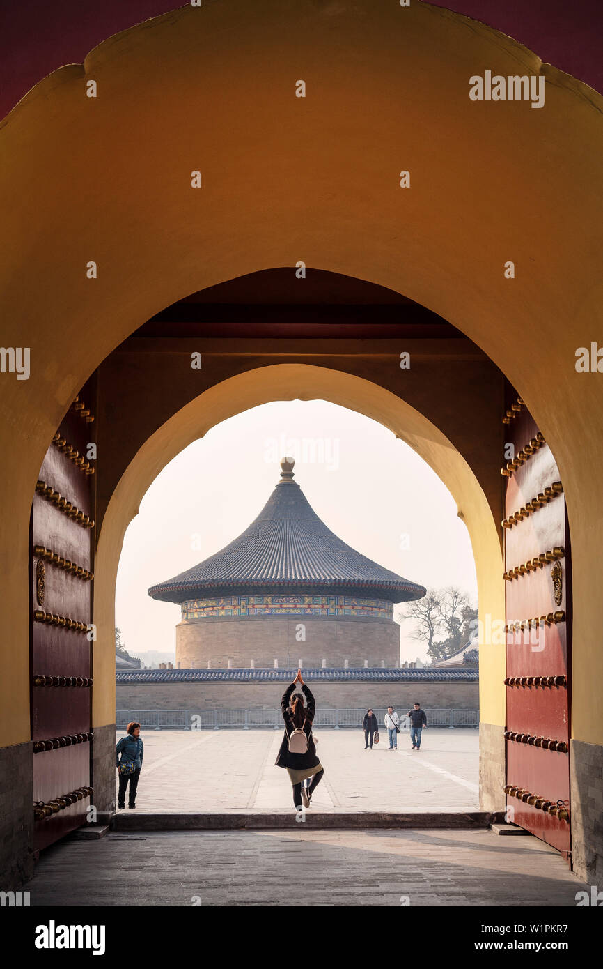 young chinese woman poses for photo at entrance to Temple of the Heaven ...