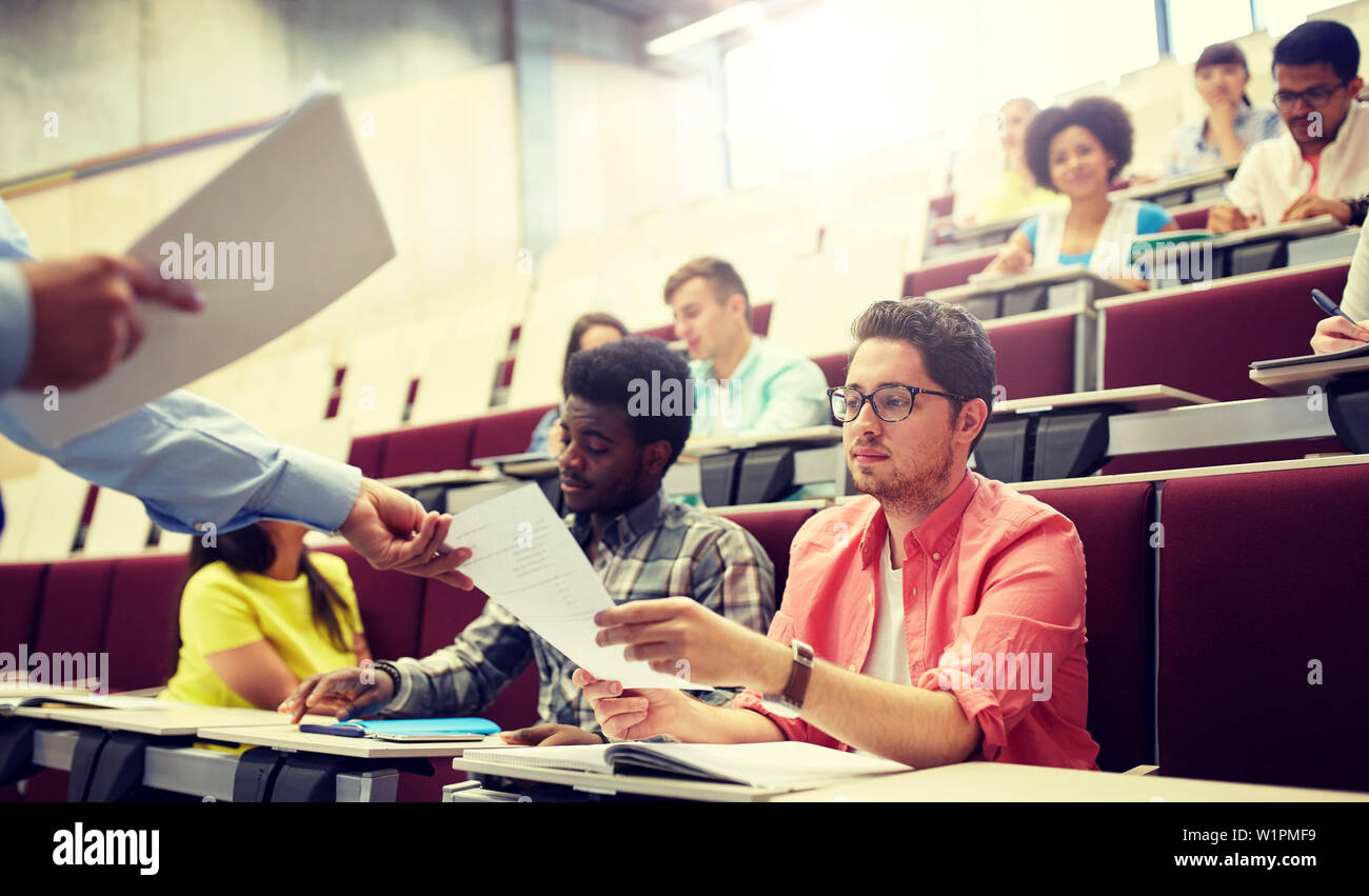 teacher giving tests to students at lecture Stock Photo - Alamy