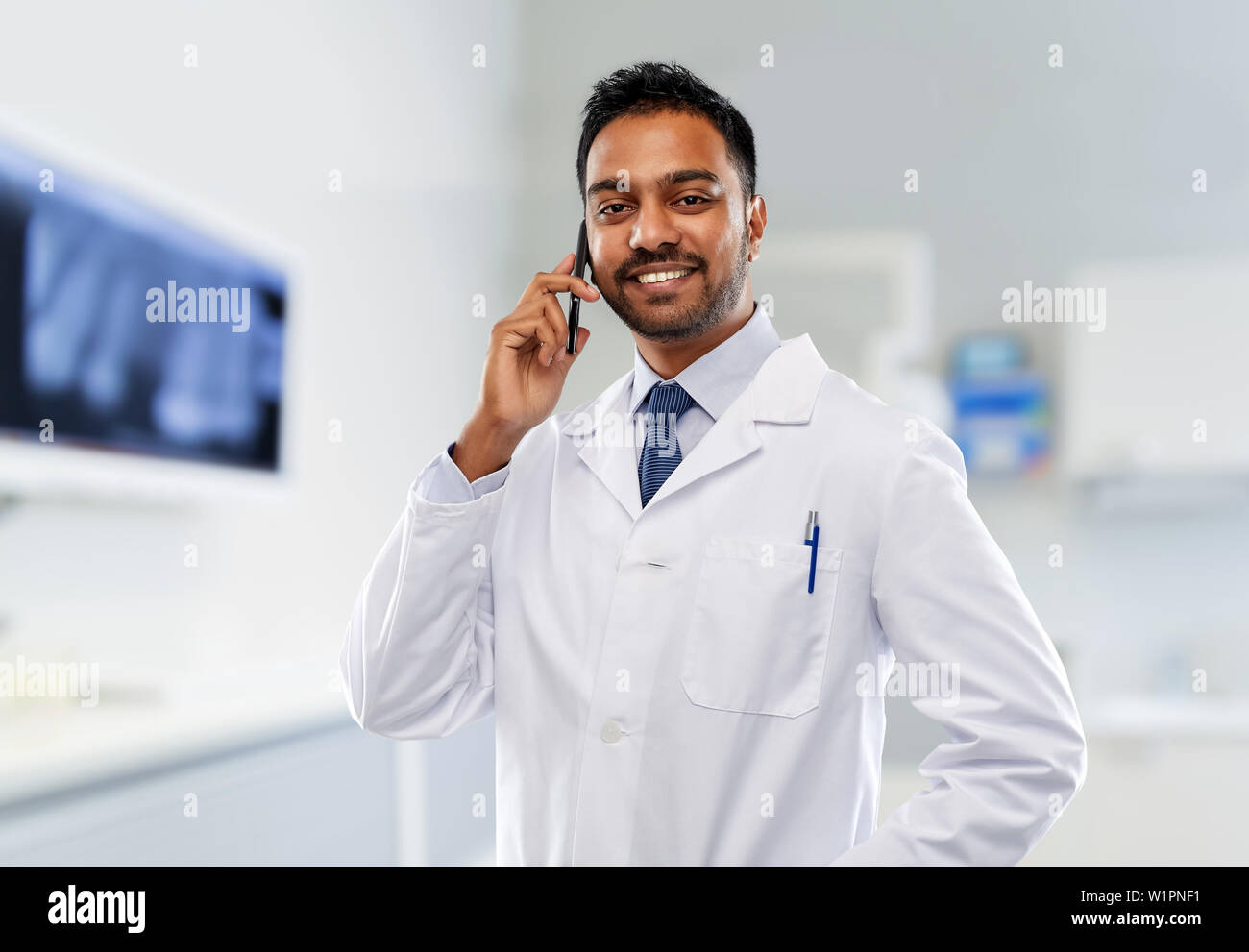 dentist calling on smartphone at dental clinic Stock Photo - Alamy