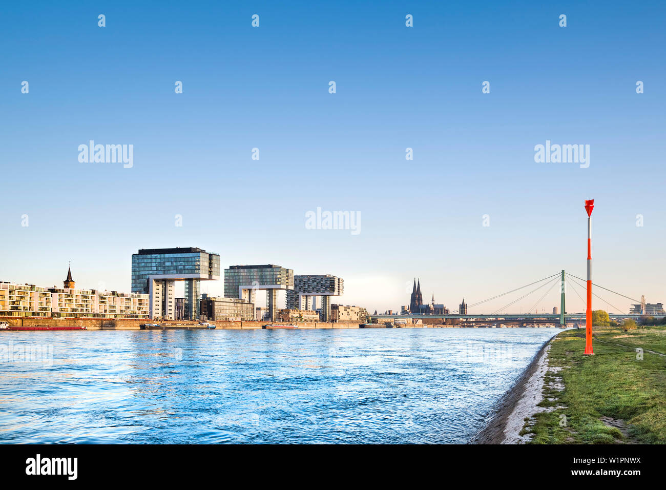 View over river Rhein towards Rheinau harbour with crane houses ...