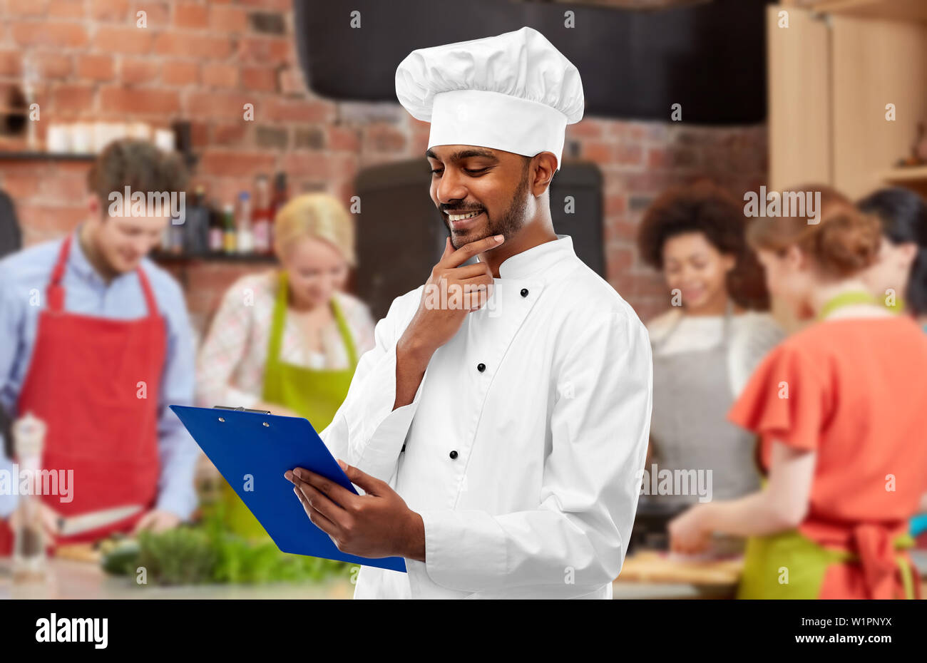 chef with menu on clipboard at cooking class Stock Photo - Alamy
