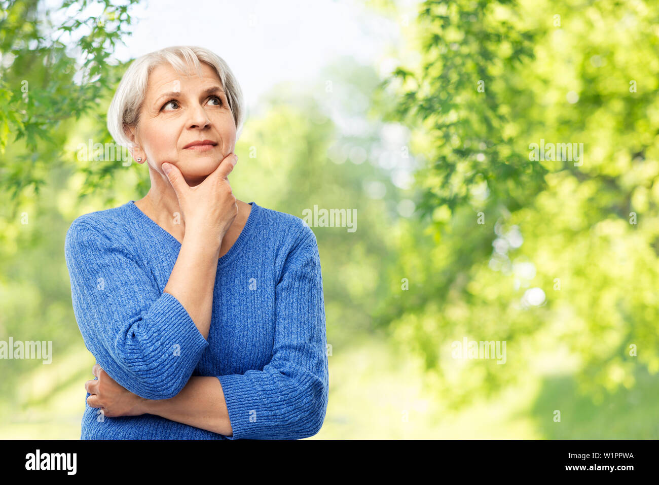 senior woman thinking over natural background Stock Photo - Alamy