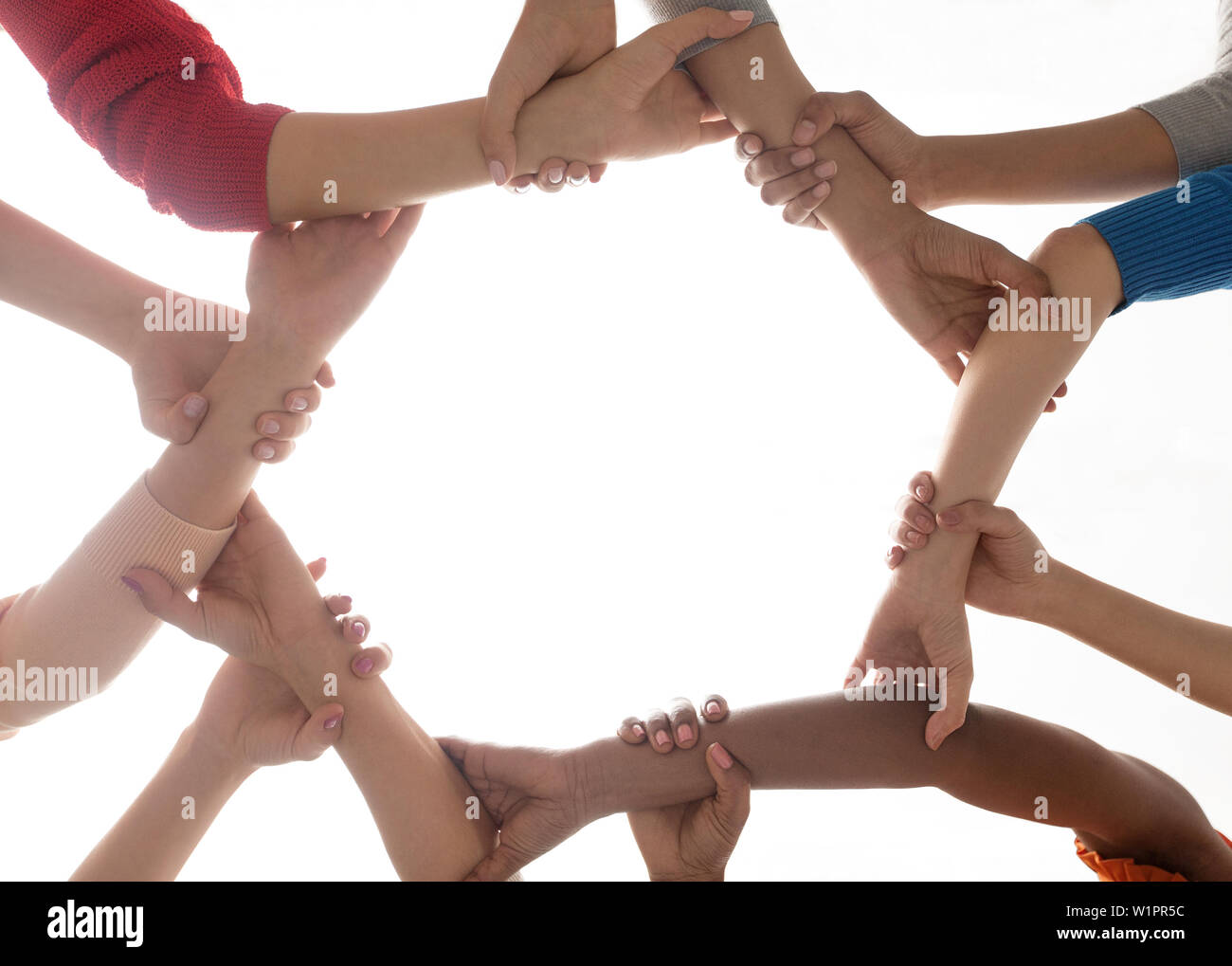 Multiracial hands holding each other hi-res stock photography and ...
