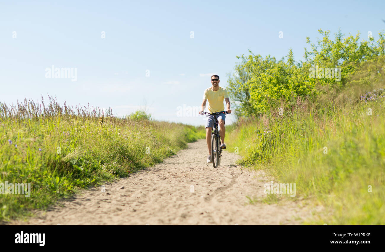 happy smiling man riding bicycle outdoors Stock Photo - Alamy