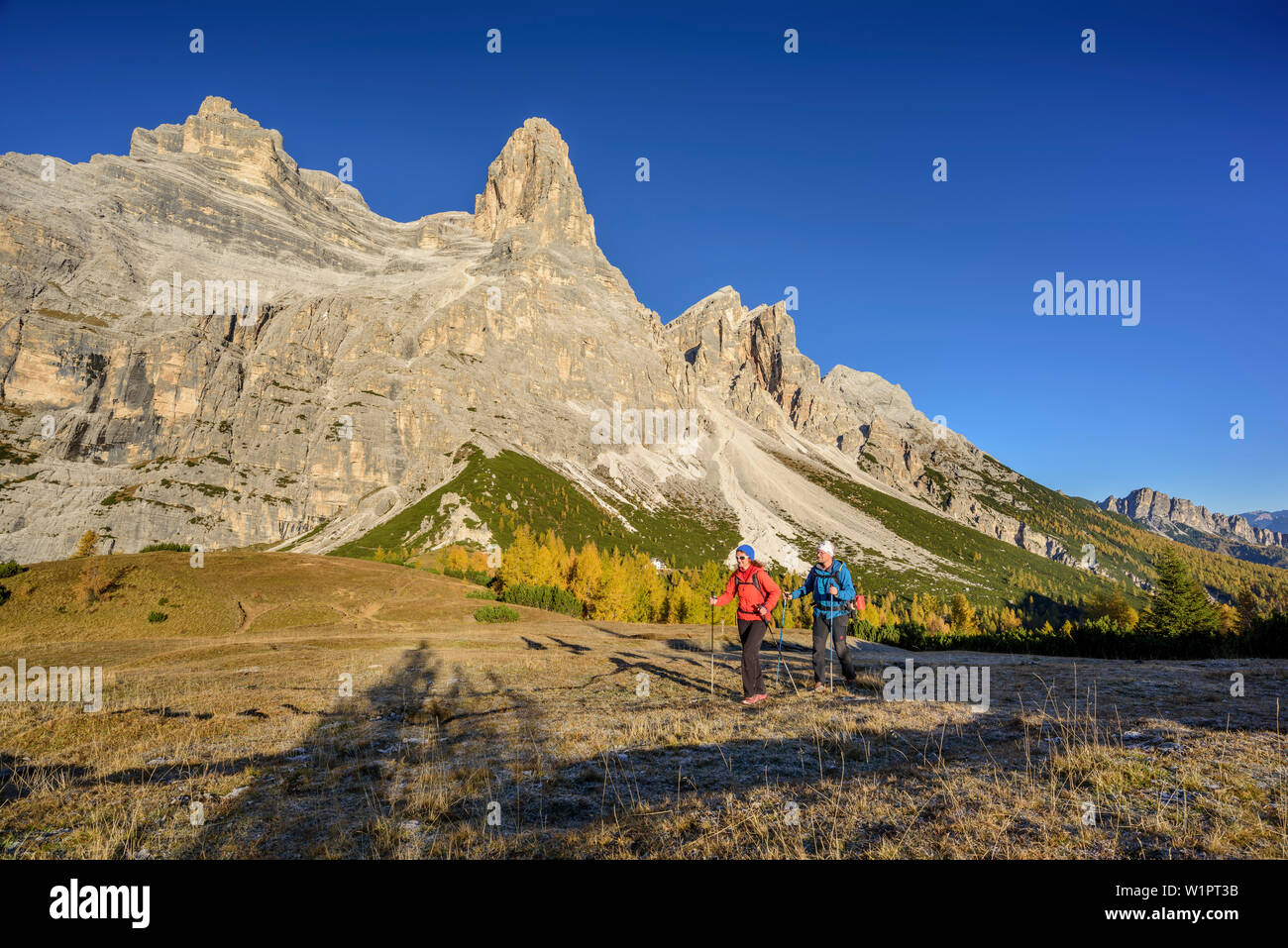 Man and woman hiking beneath Monte Pelmo, Monte Pelmo, Dolomites ...