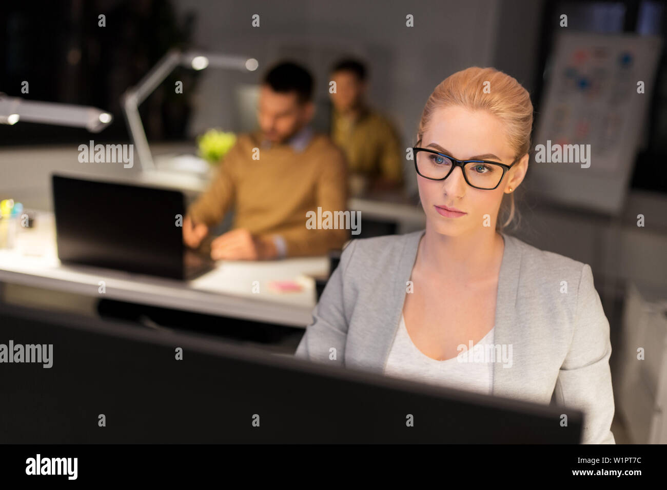 businesswoman working on computer at night office Stock Photo - Alamy