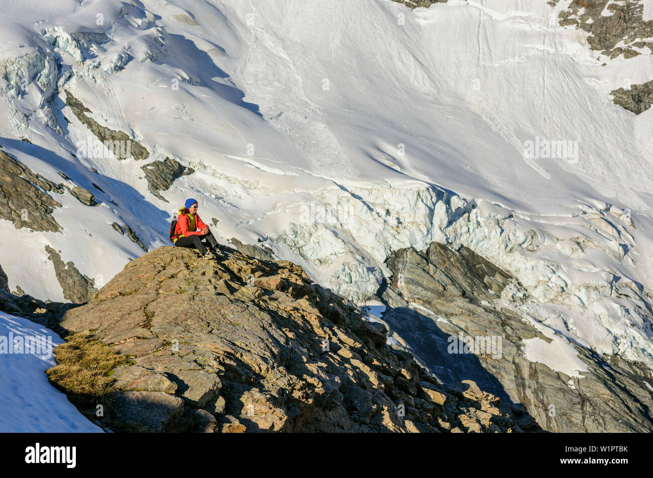 Woman sitting on rock, glacier in background, from Mueller Hut, Hooker ...