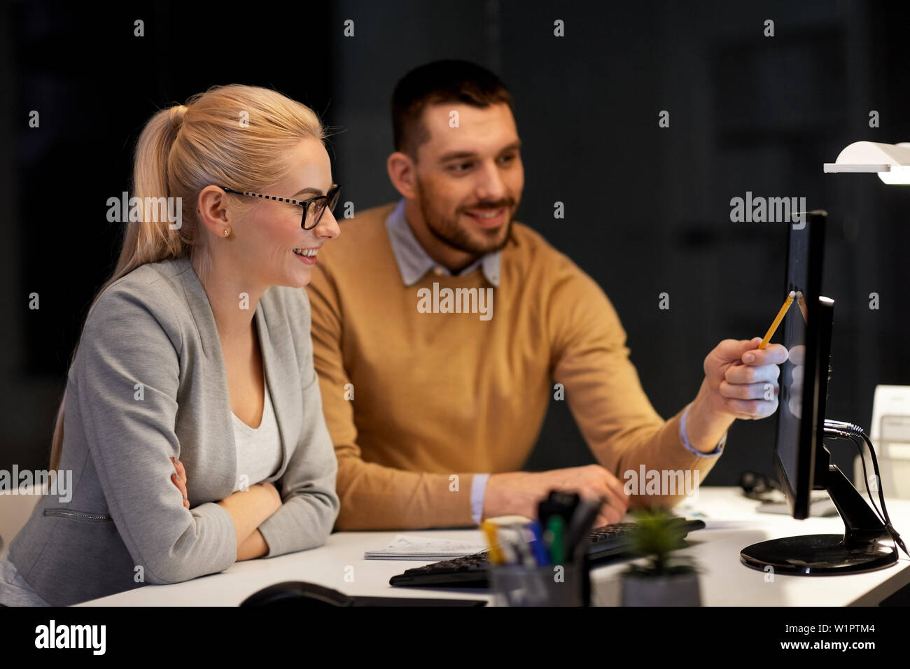 business team with computer working late at office Stock Photo - Alamy