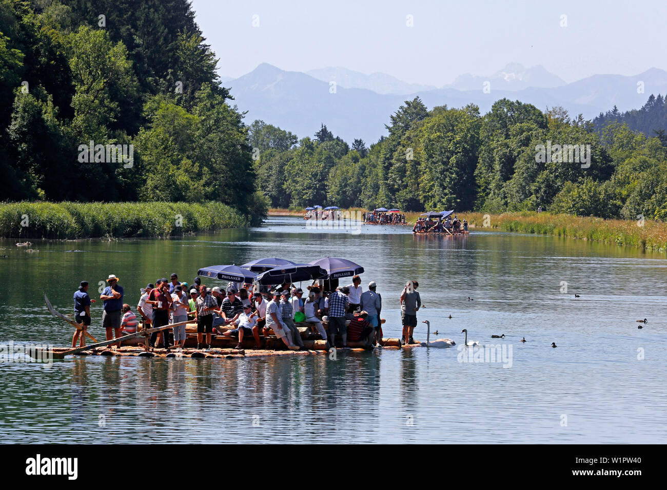 People on a traditional wood raft, river Isar, Munich, Upper Bavaria ...