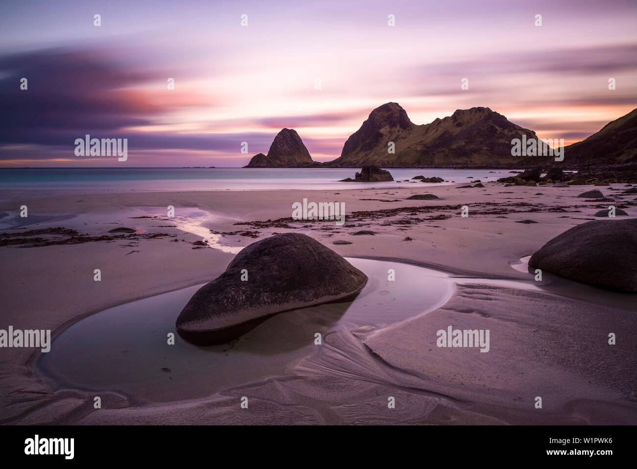tidal pool in the midnight sun on a sandy beach near the city of Sto ...