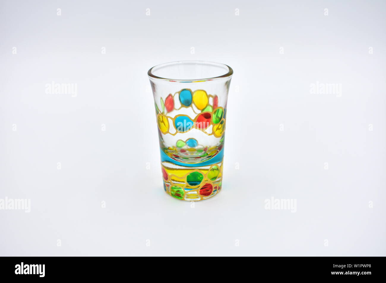 Small glass with colours isolated on a white background Stock Photo - Alamy