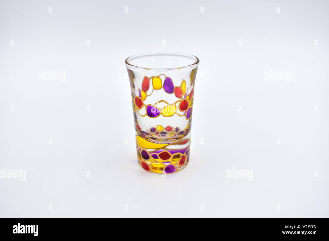 Small glass with colours isolated on a white background Stock Photo - Alamy