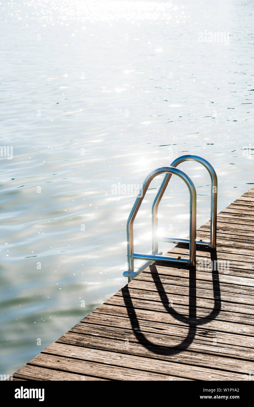 A bathing ladder with wood jetty against the light, Fort Myers Beach ...