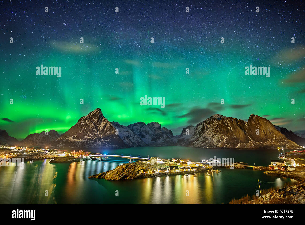 Island near Hamnoy and illuminated houses with polar lights and stary ...