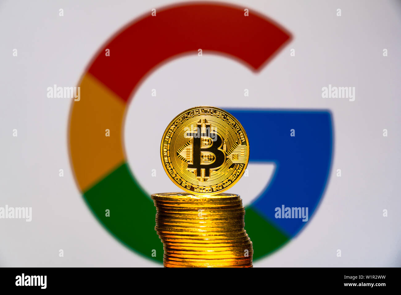 Gold Bitcoin coins with the Google logo on background screen Stock ...