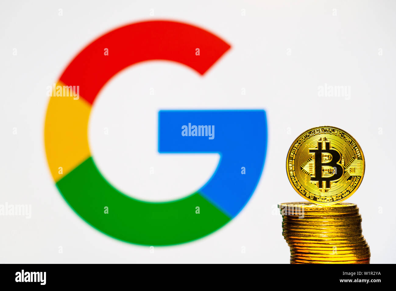 Gold Bitcoin coins with the Google logo on background screen Stock ...