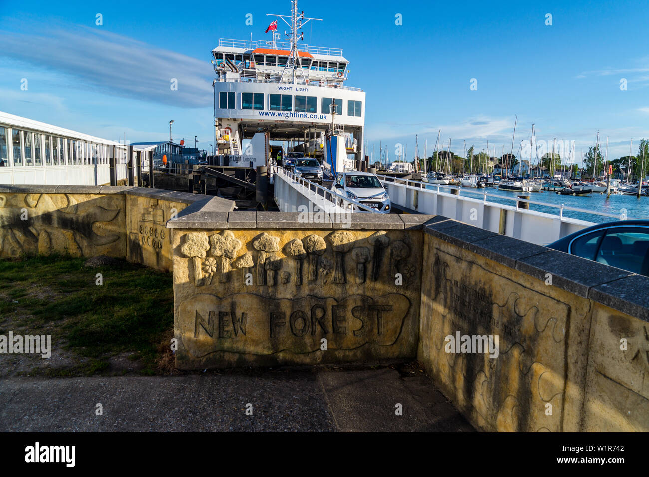 Vehicles disembarking "Wight Light" ferry of the Wightlink line docking ...