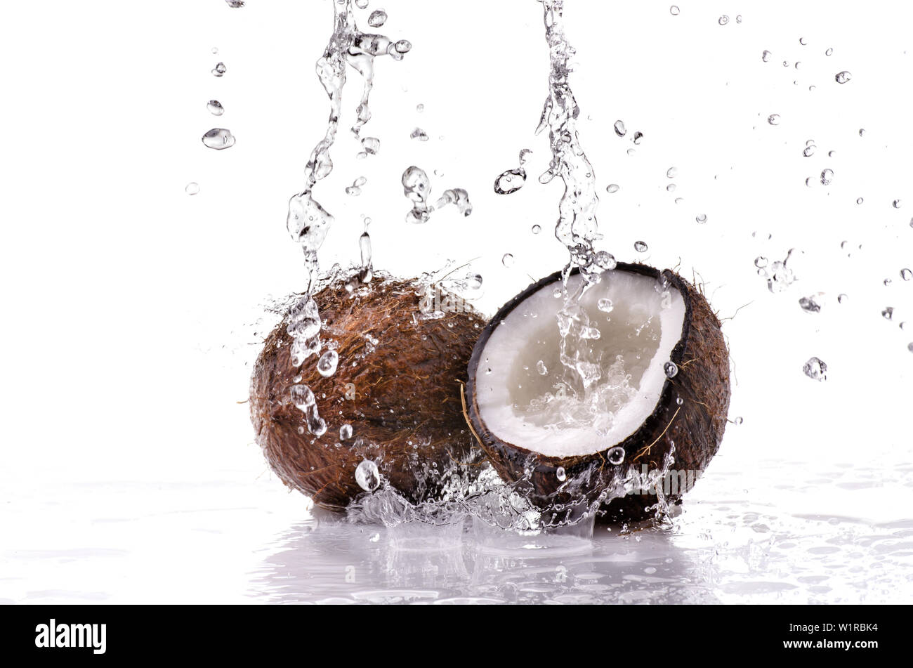 wet coconuts to an overflowing cascade of fresh liquid Stock Photo - Alamy
