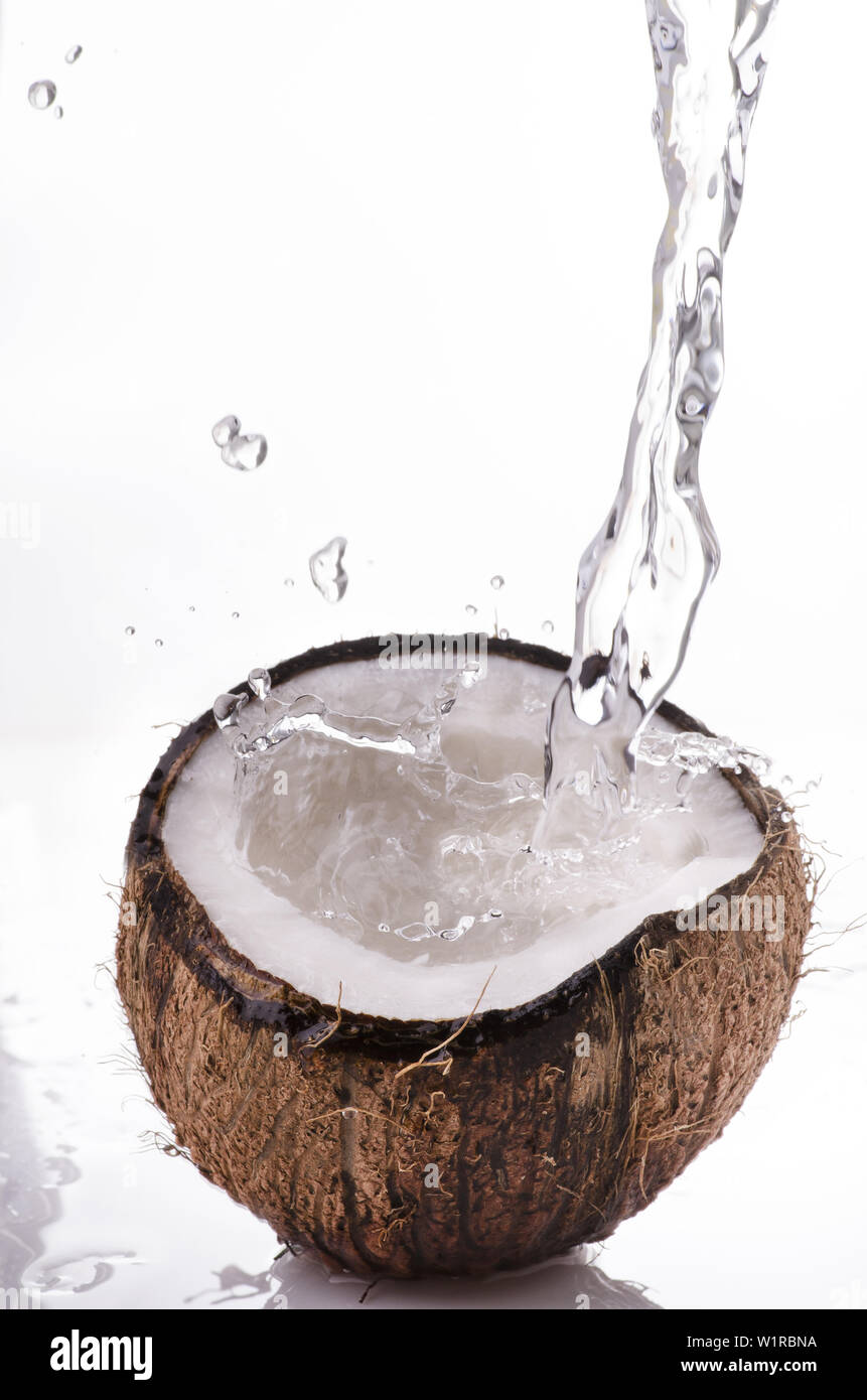 wet coconuts to an overflowing cascade of fresh liquid Stock Photo - Alamy