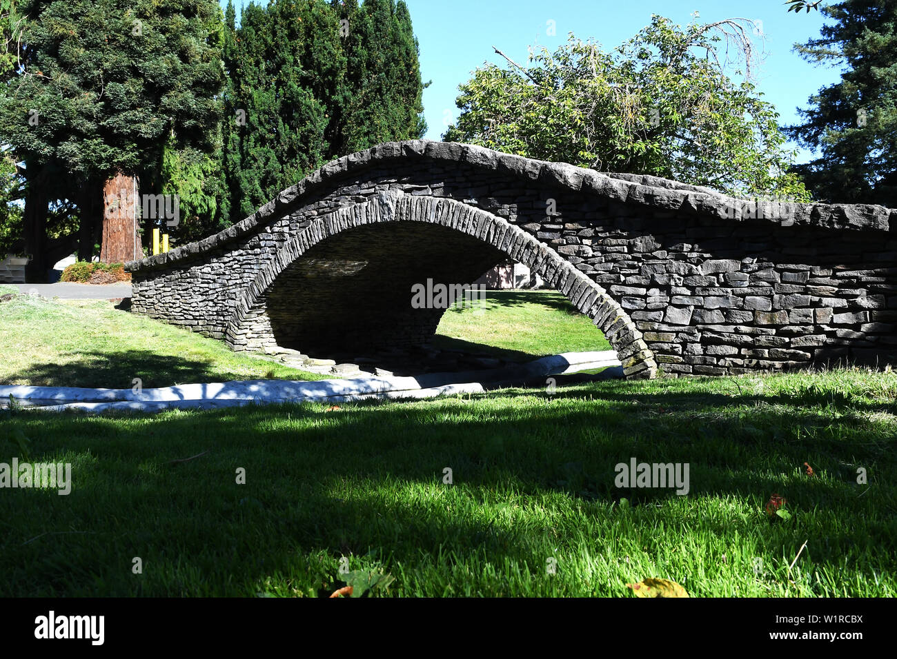 Small Stone viaduct bridge in a local park across small river in Santa ...
