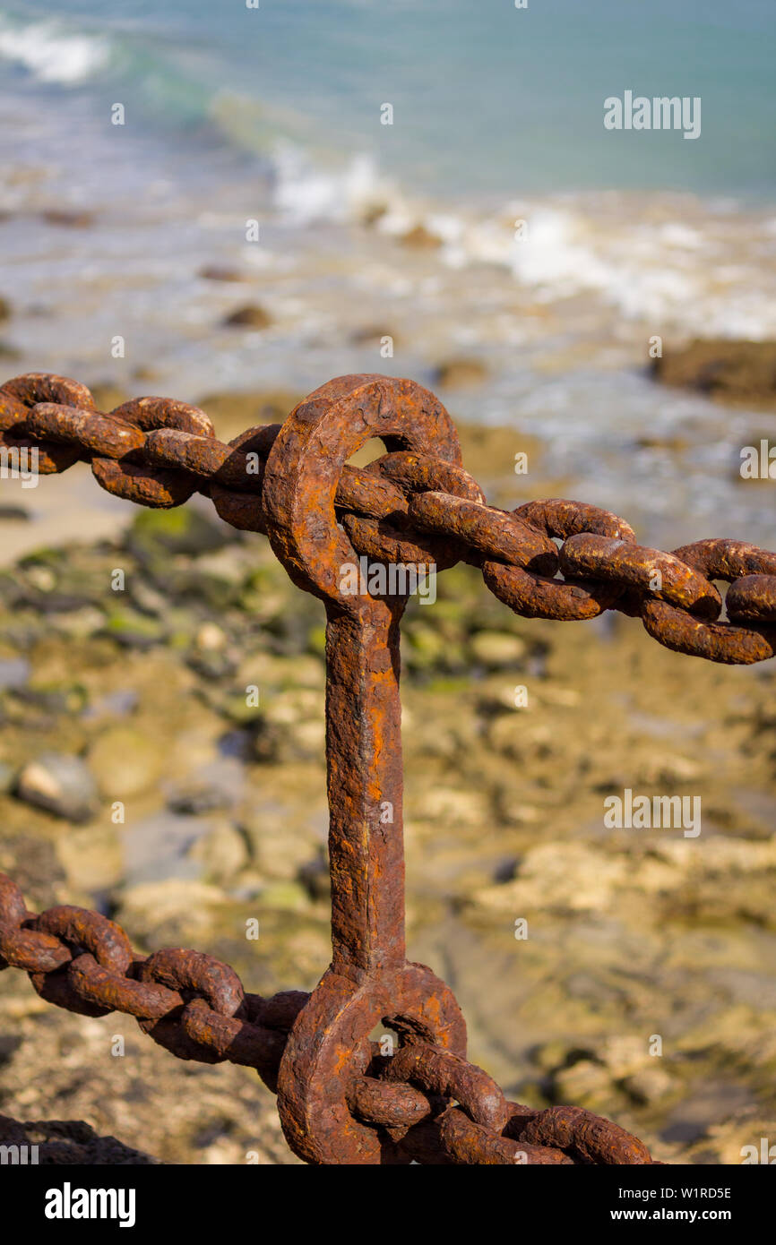View of a rusty chain near the beach Stock Photo - Alamy