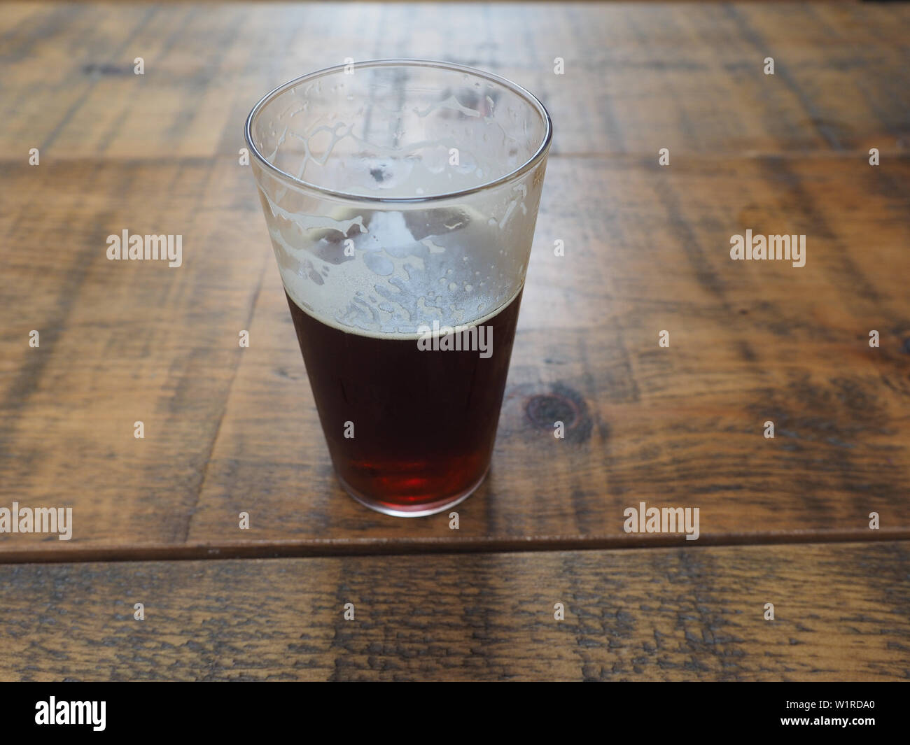 a pint of British ale beer on a wooden pub table Stock Photo - Alamy