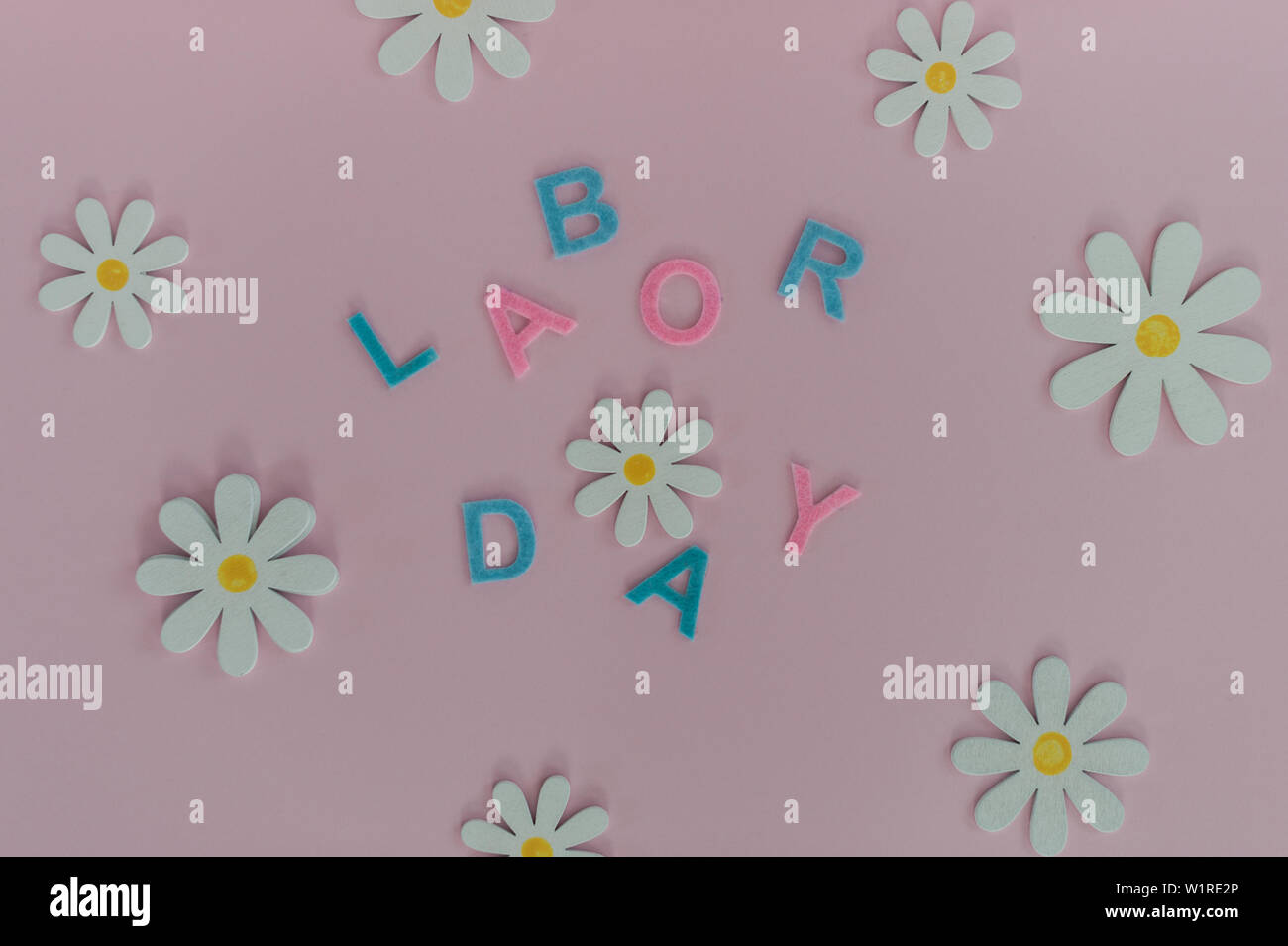 The inscription labor Day on a beautiful pink background. Holiday ...