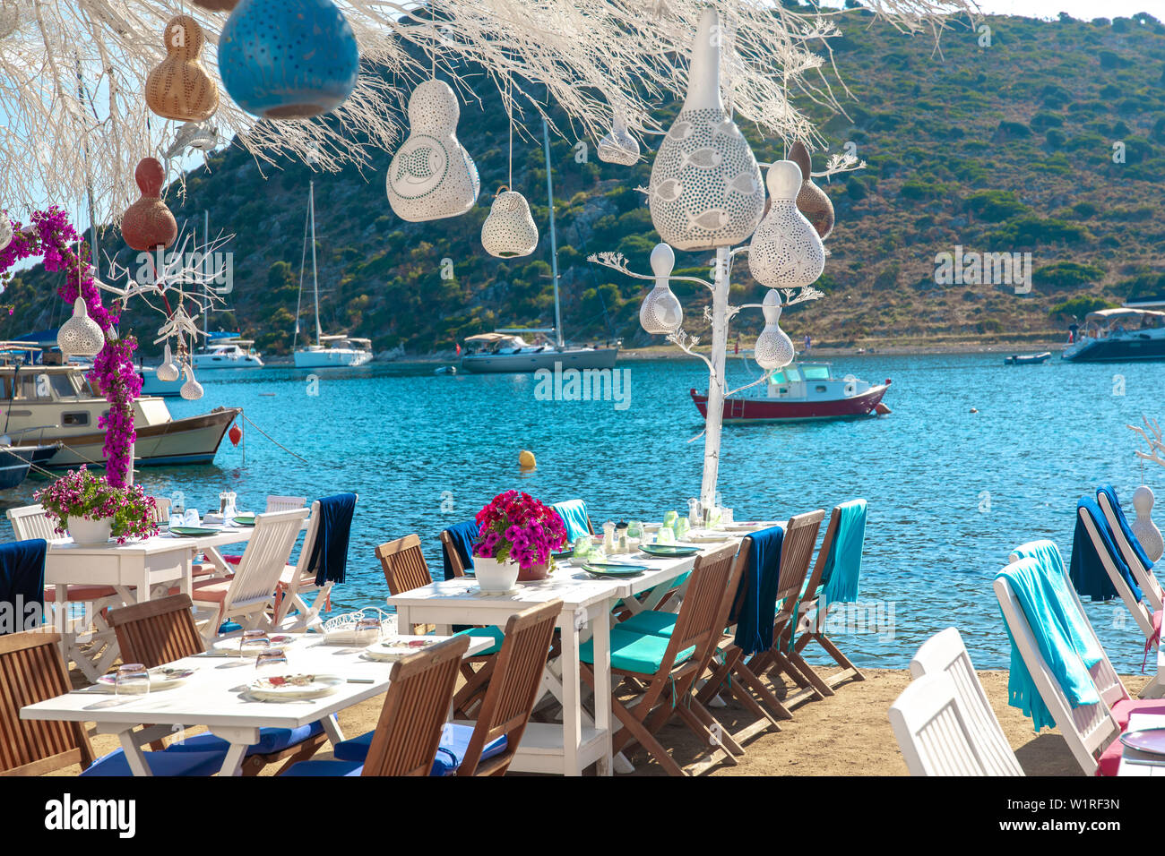 View of fish restaurant, cafe and bougainvillea flowers on beach in ...
