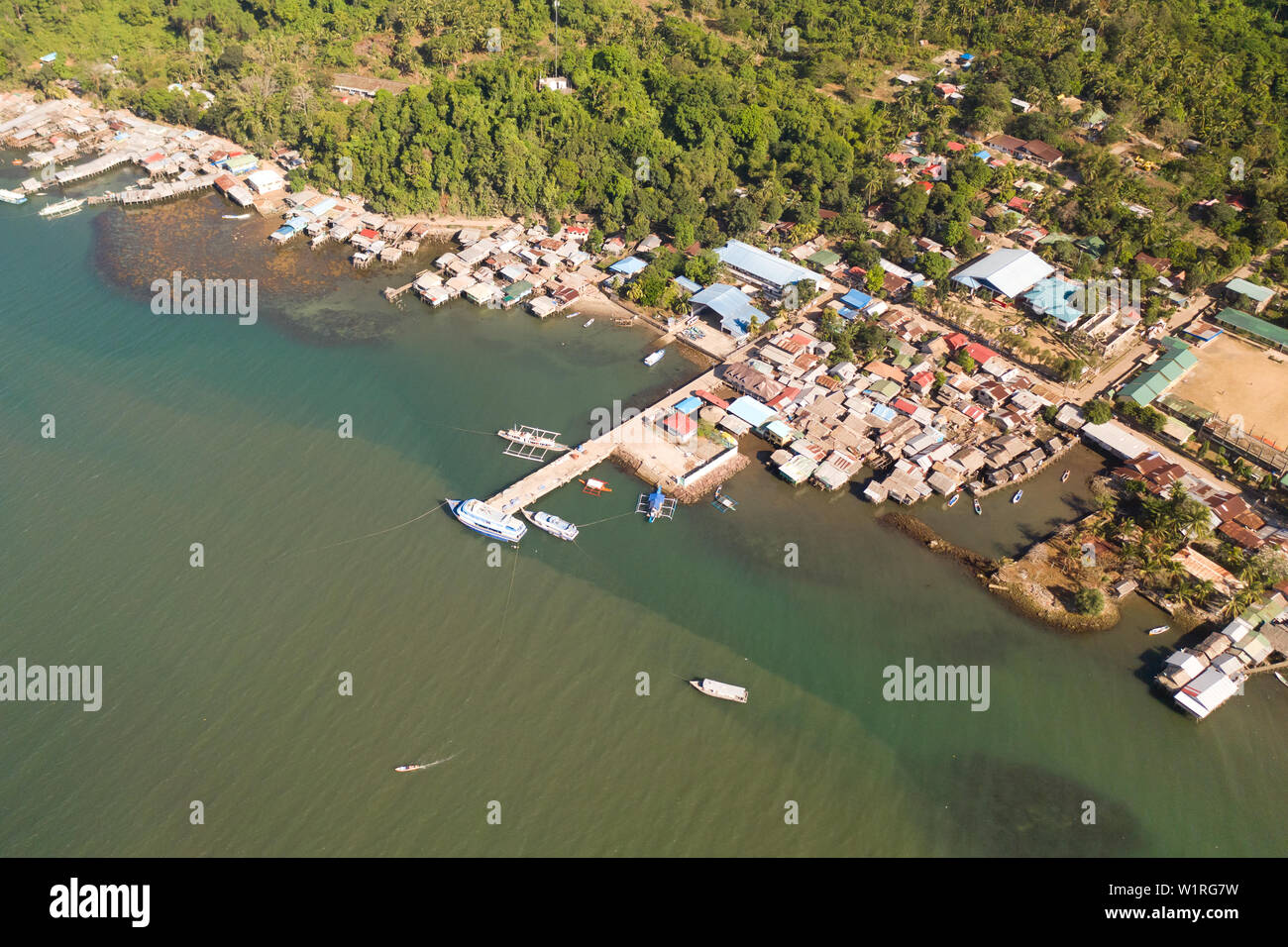Balabac port. Houses on the water and various boats in the bay, view ...