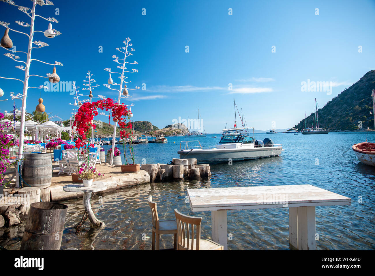 View of fish restaurant, cafe and bougainvillea flowers on beach in ...