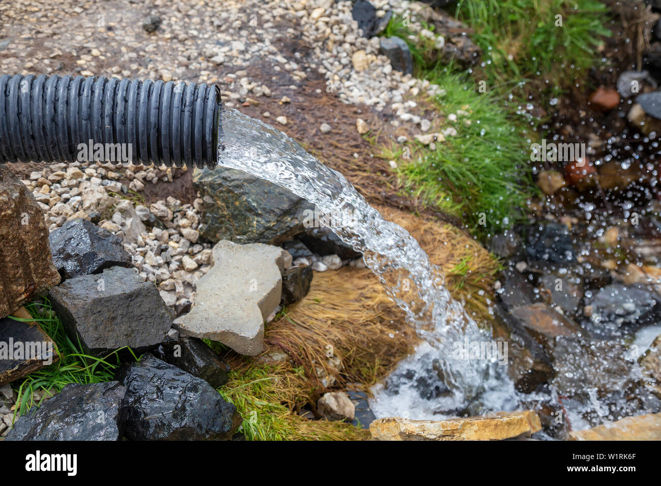 Stream of clean water from deep well without electricity. Cool and ...