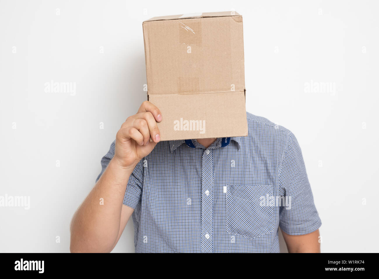 Description: An anonymous man with a box on his head concealing his ...