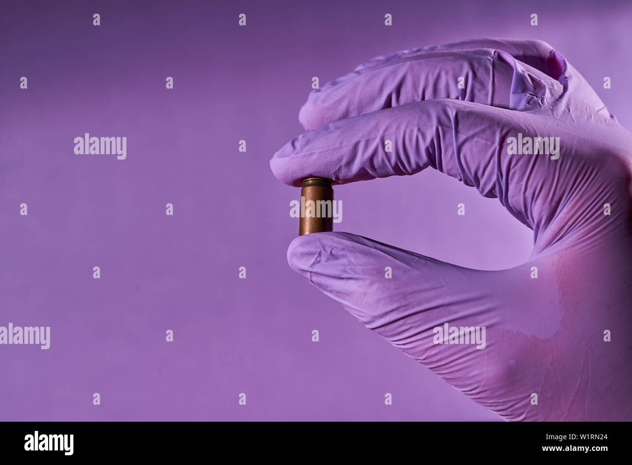 Glove holding bullet hi-res stock photography and images - Alamy