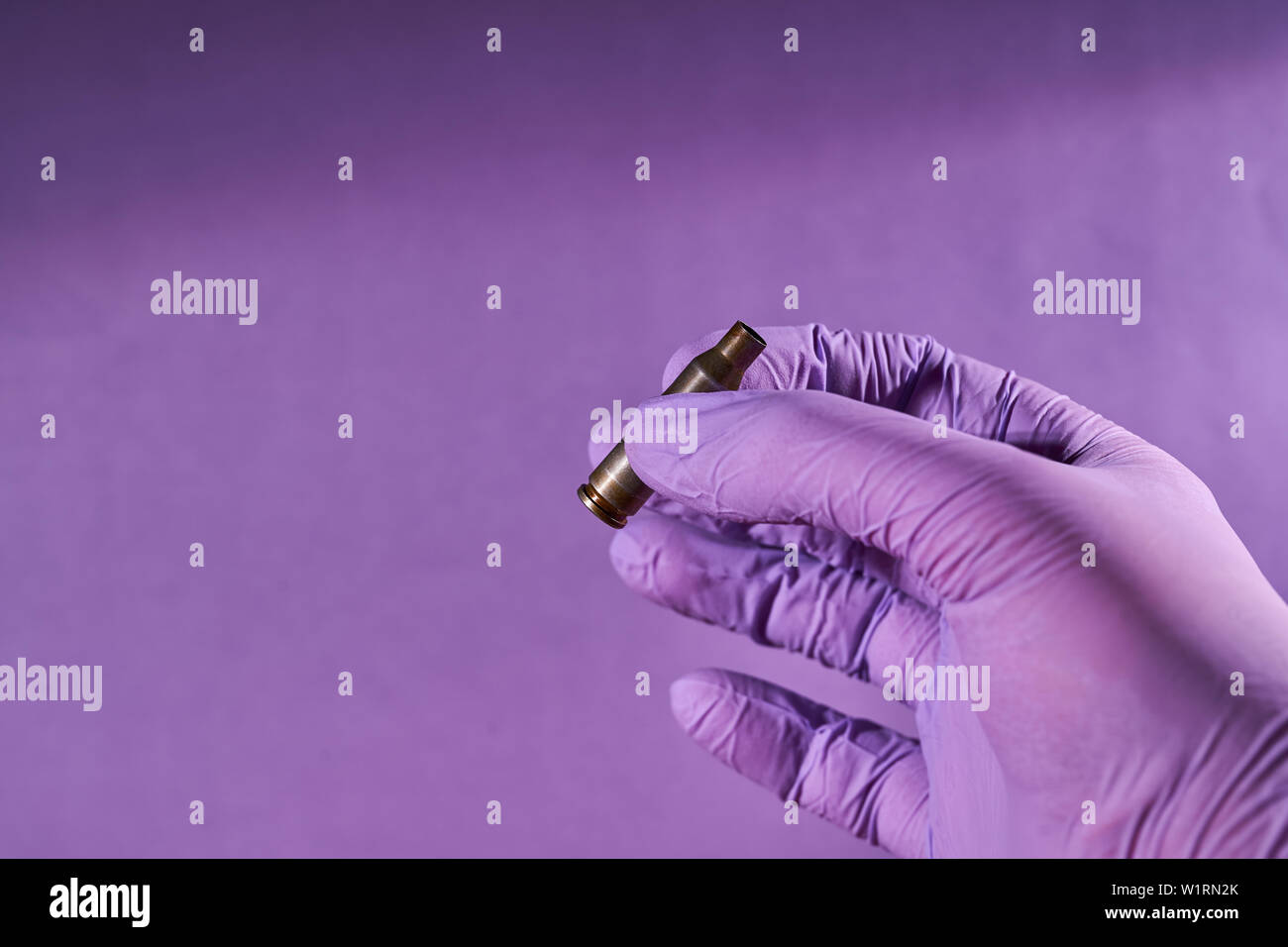 Glove holding bullet hi-res stock photography and images - Alamy