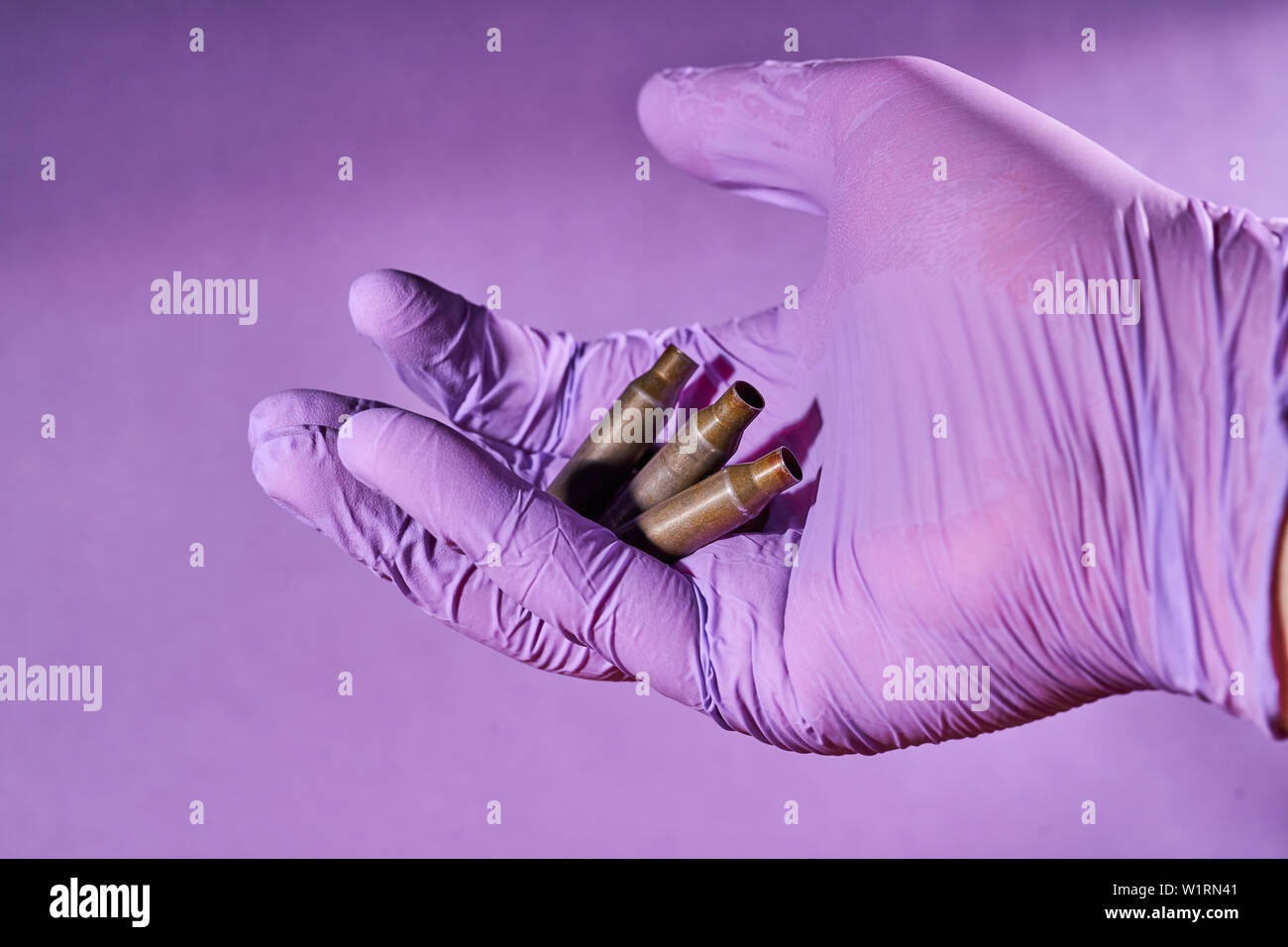 Glove holding bullet hi-res stock photography and images - Alamy