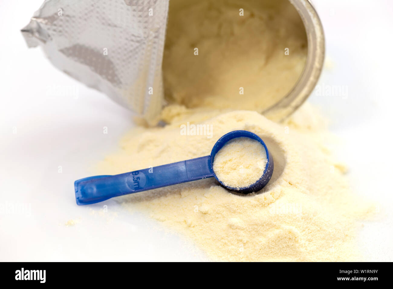 Powdered milk with spoon for baby on white background Stock Photo - Alamy